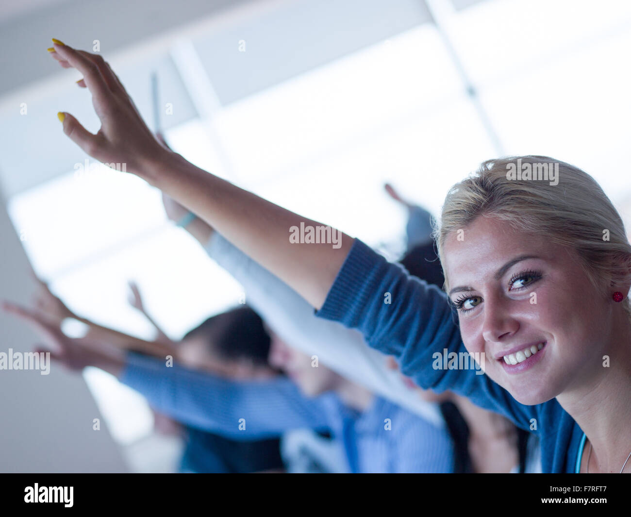 students group raise hands up in classroom Stock Photo - Alamy