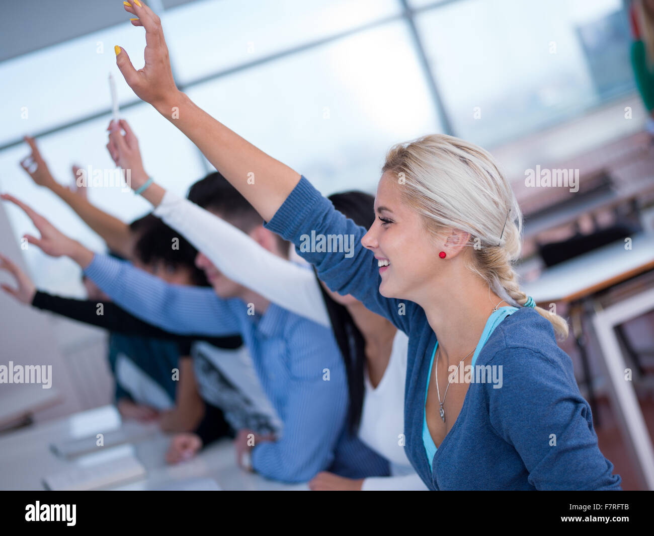 students group raise hands up in classroom Stock Photo - Alamy