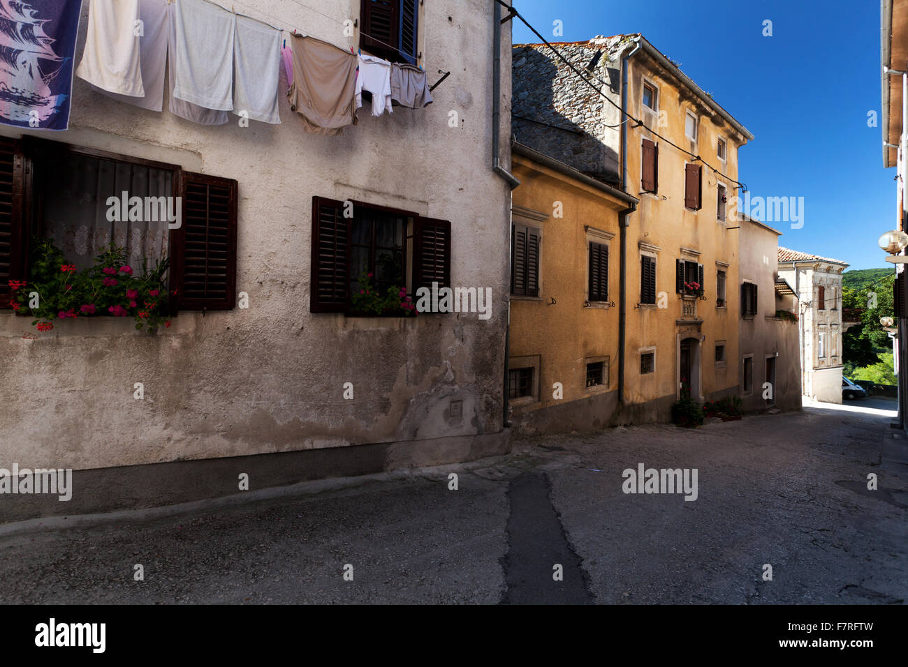 A street in Buzet Old City, Croatia. Nice sun reflection on houses ...