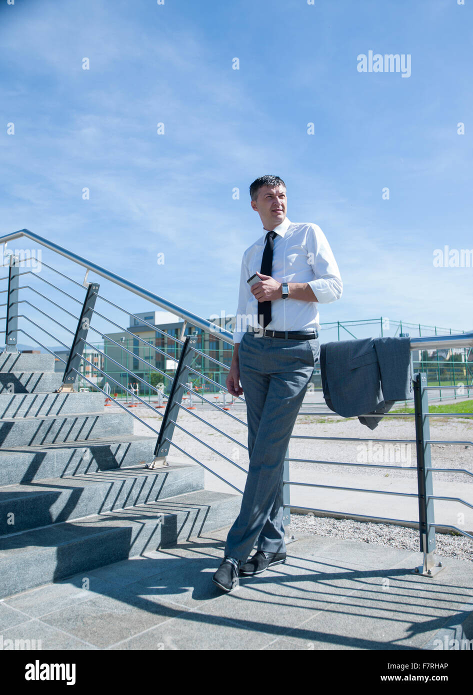 portrait of middle aged business man standing outdoor on stairs Stock ...