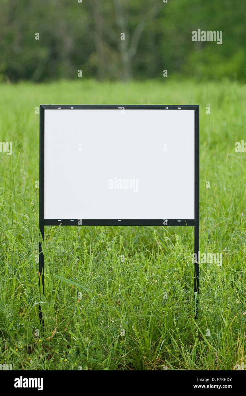 Blank Sign in Overgrown Field Vertical Stock Photo - Alamy