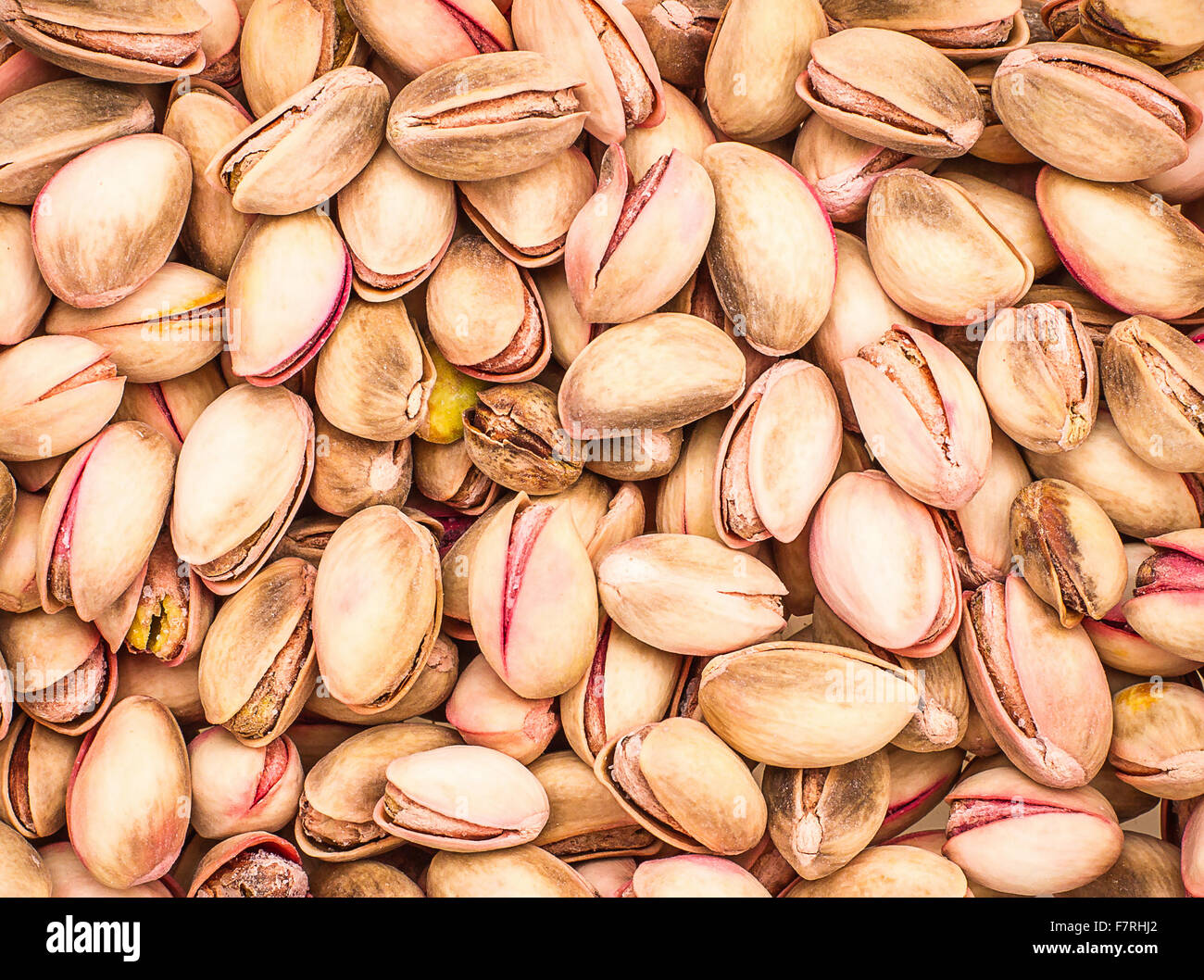 Cretan pink pistachios as background, greek food, top view Stock Photo ...