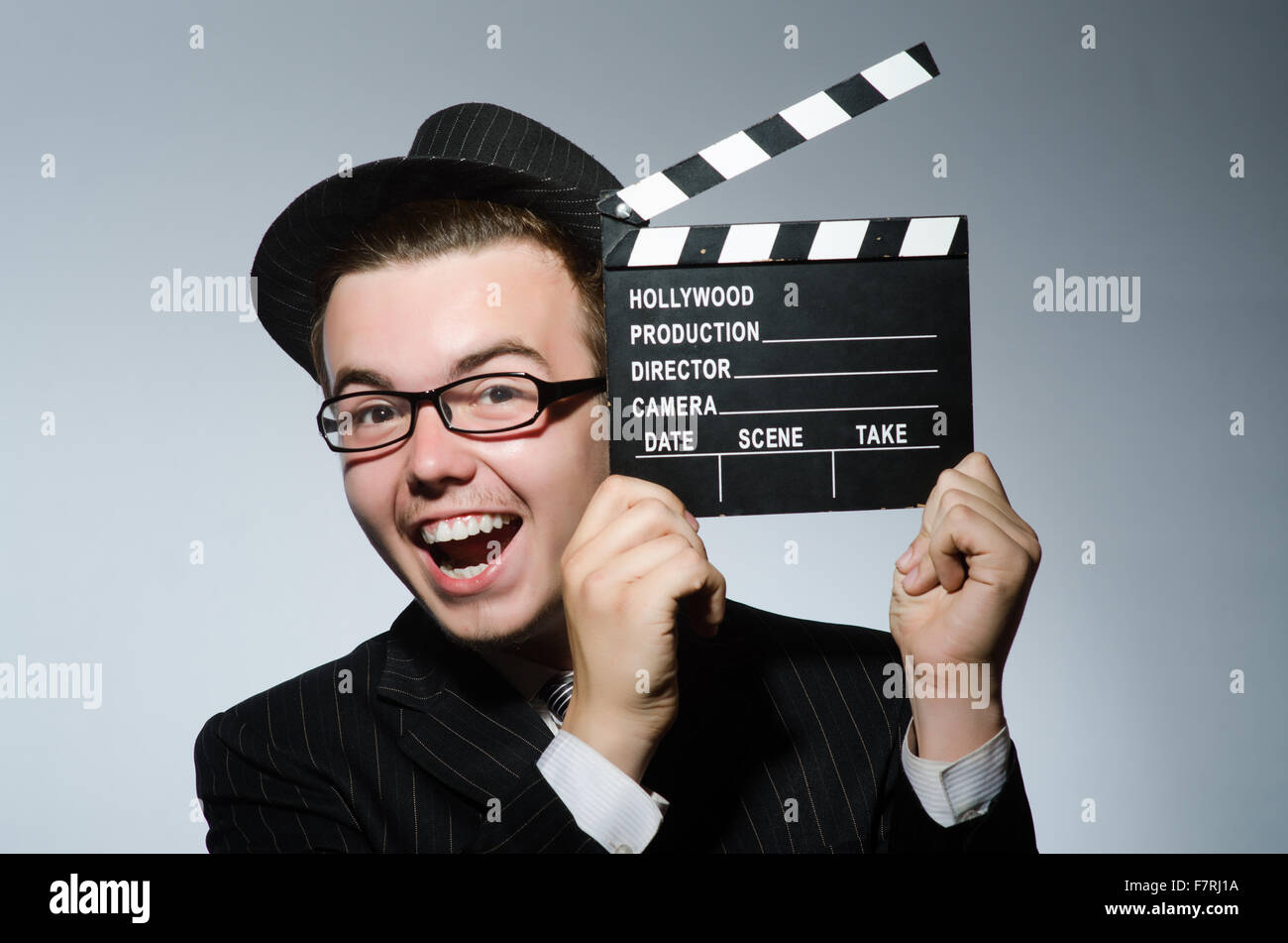 Man with movie clapperboard and hat Stock Photo - Alamy