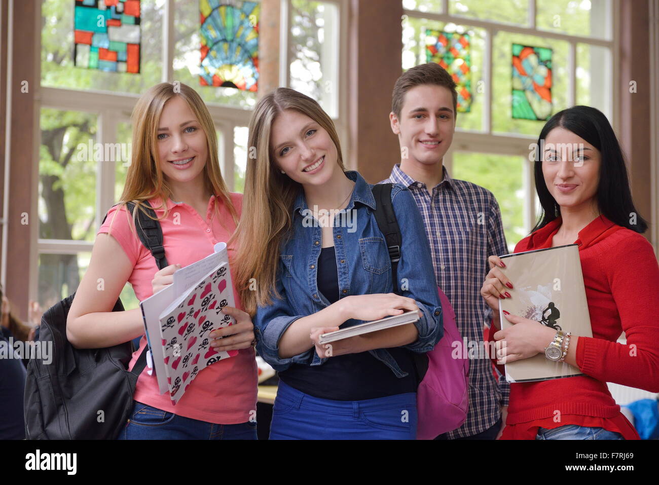 happy young teens group in school have fun an learning lessons Stock ...