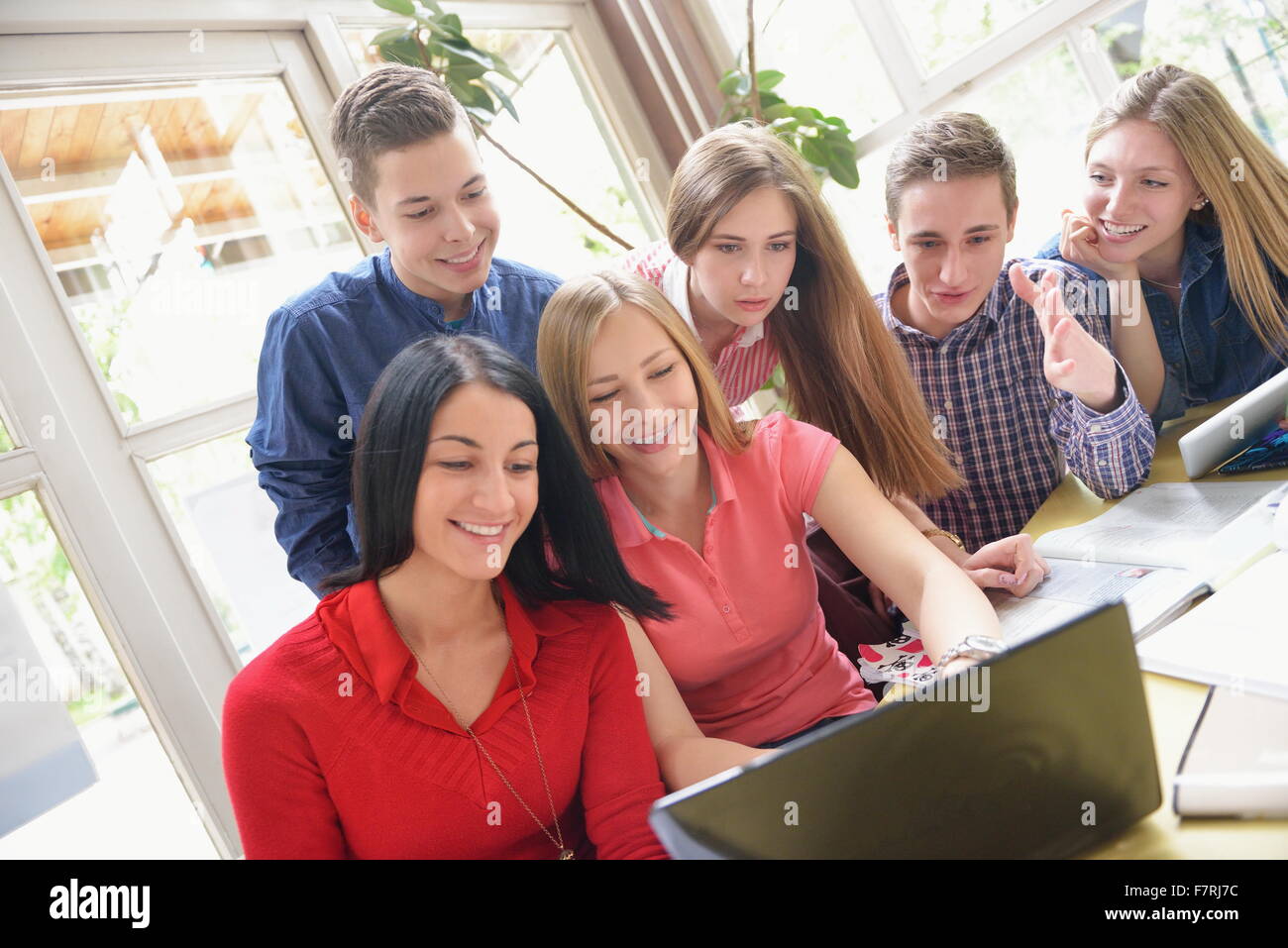 happy young teens group in school have fun an learning lessons Stock ...