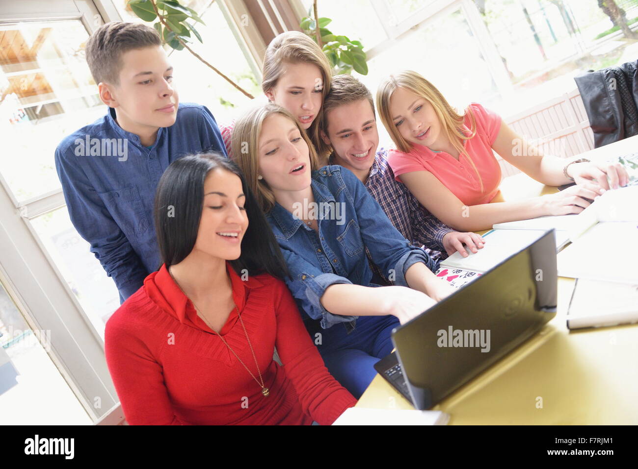 happy young teens group in school have fun an learning lessons Stock ...