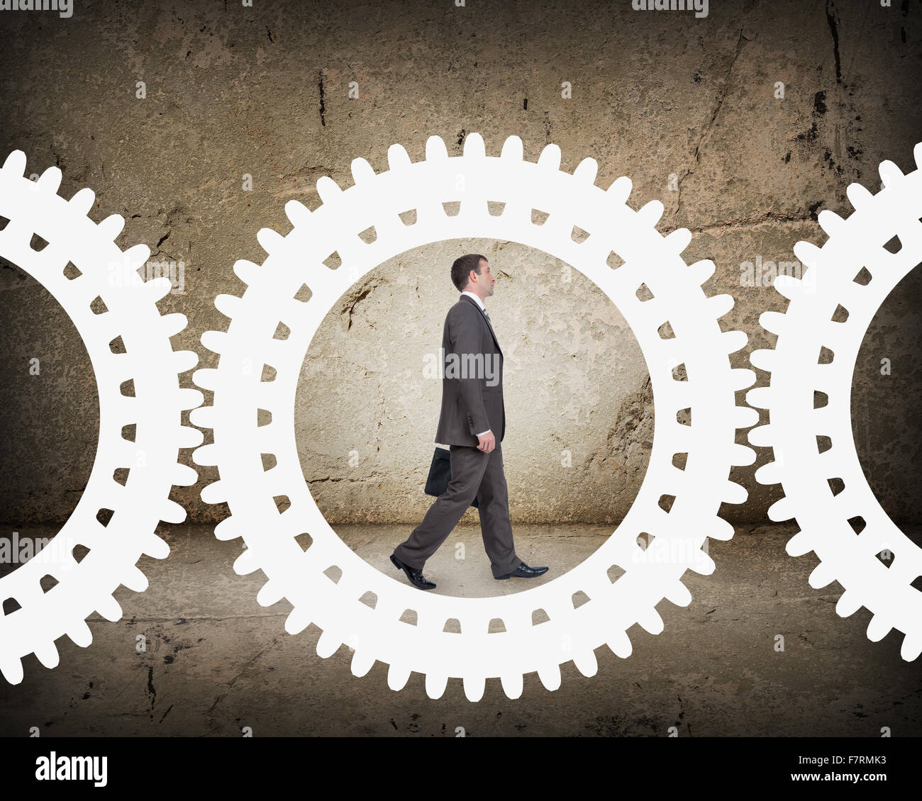 Man walking in cog wheel Stock Photo - Alamy