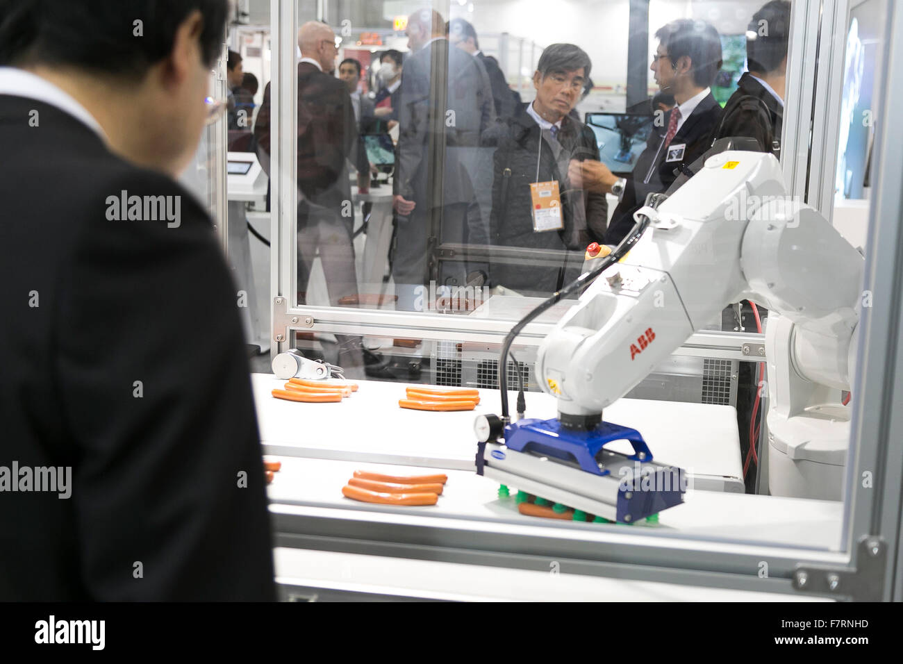 A man looks at the ABB robotics' arm robot at the International Robot ...