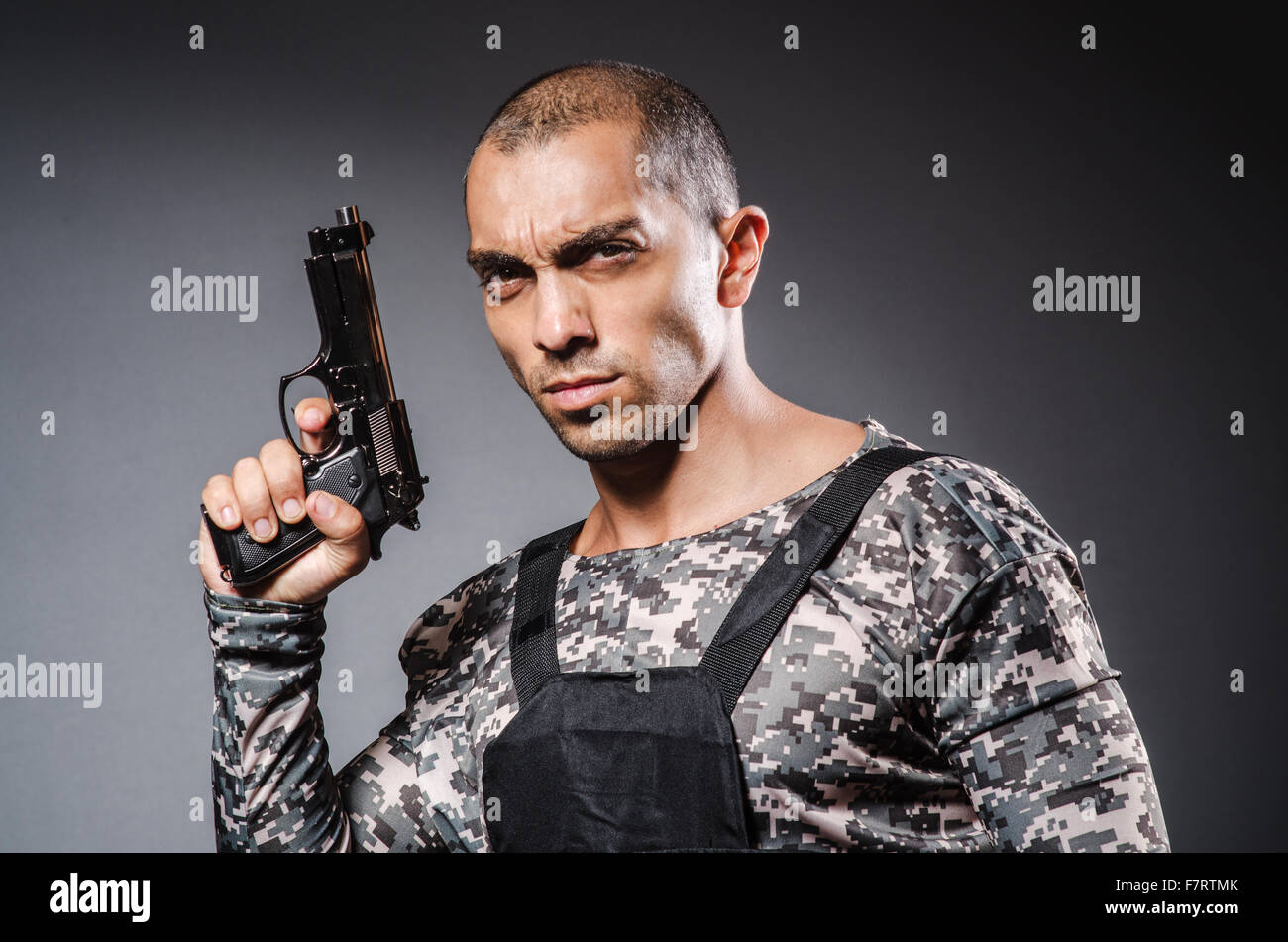 Soldier with guns against dark background Stock Photo - Alamy