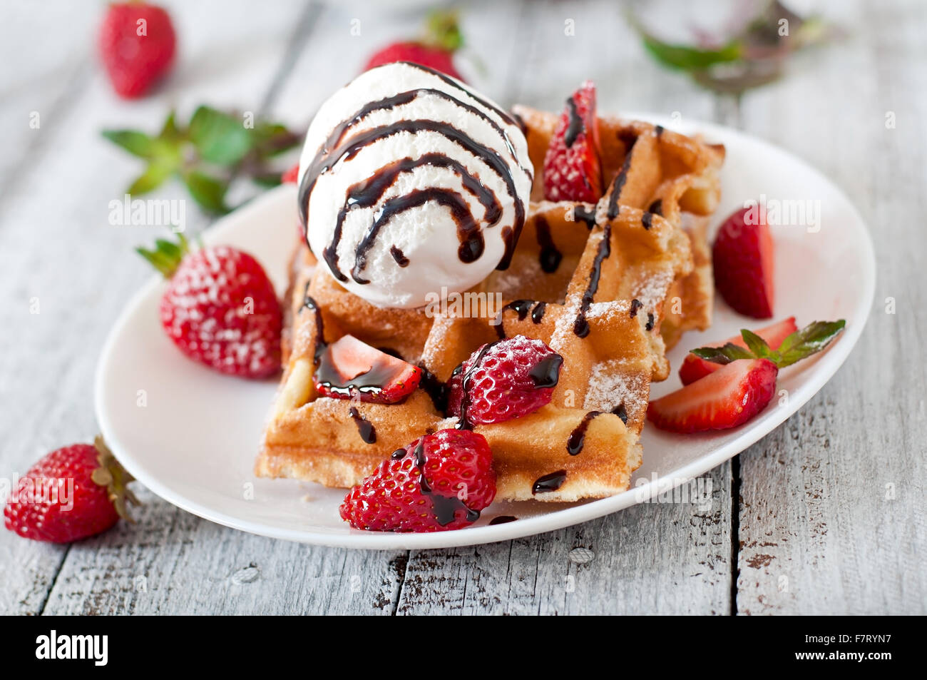 Belgium Waffles With Strawberries And Ice Cream On White Plate Stock
