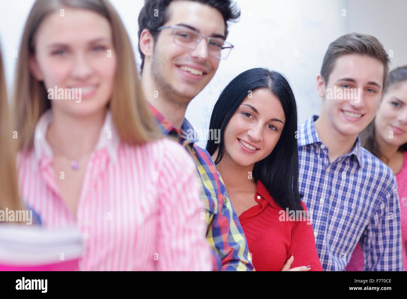 happy young teens group in school have fun an learning lessons Stock ...