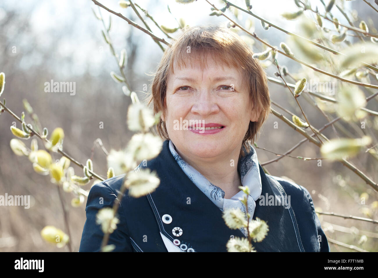 Smiling senior woman in spring willow twig with buds outdoor Stock ...