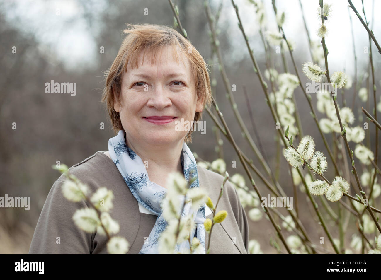 Smiling senior woman in spring willow twig with buds outdoor Stock ...