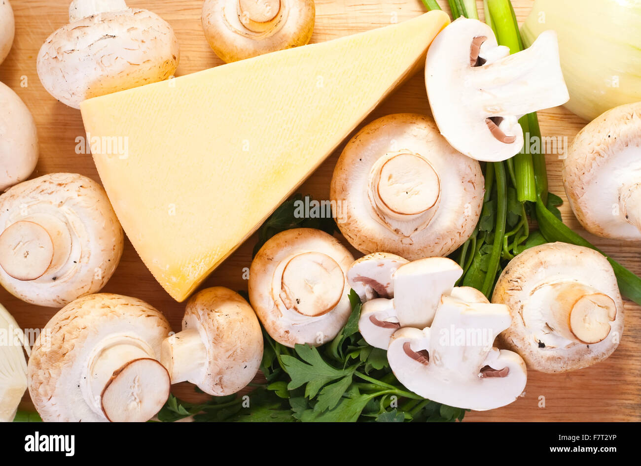Closeup of champignon mushroom with cheese on cutting board o Stock ...