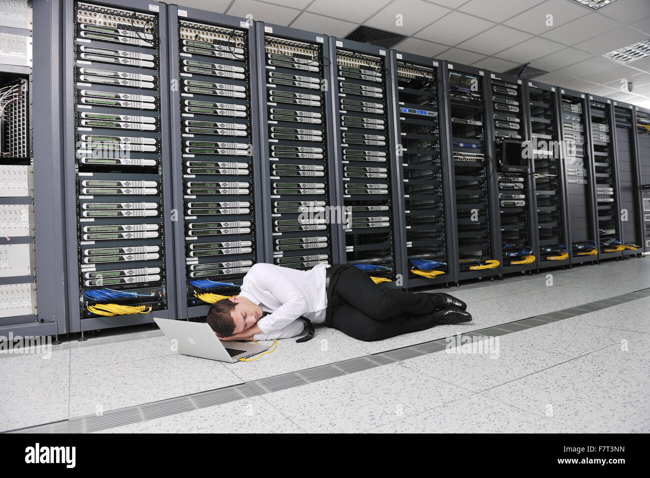it business man in network server room have problems and looking for ...