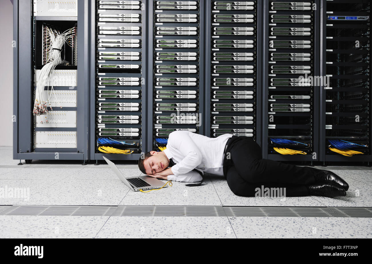 it business man in network server room have problems and looking for ...
