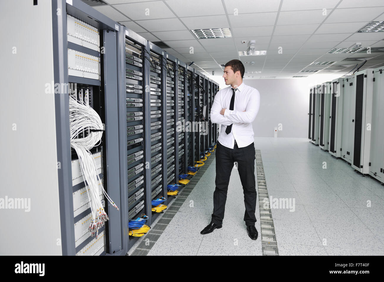 young handsome business man engeneer in datacenter server room Stock ...