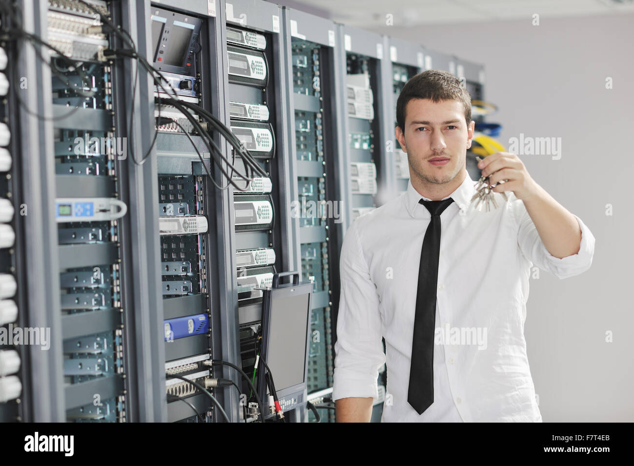 young handsome business man engeneer in datacenter server room Stock ...