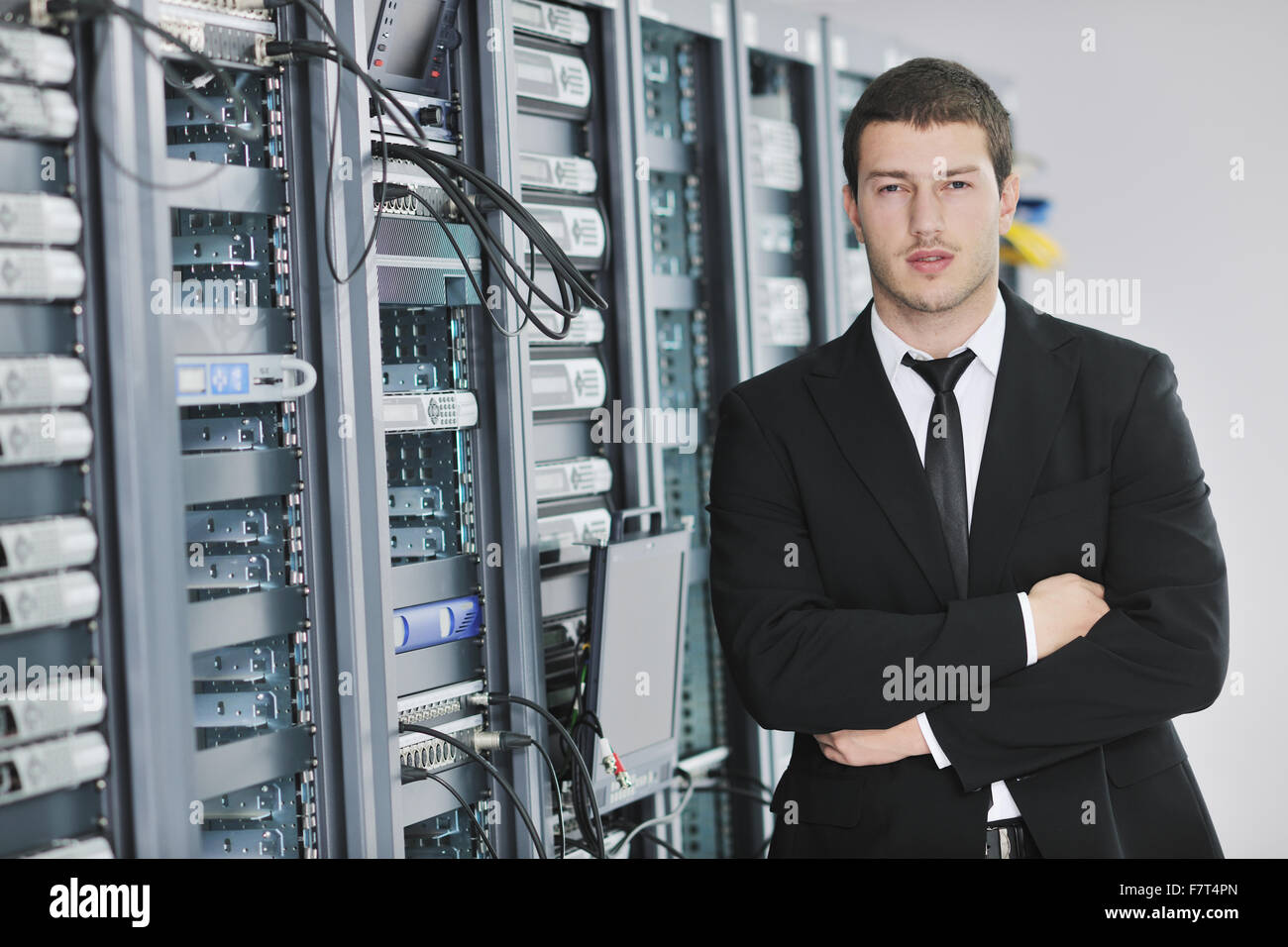 young handsome business man engeneer in datacenter server room Stock ...