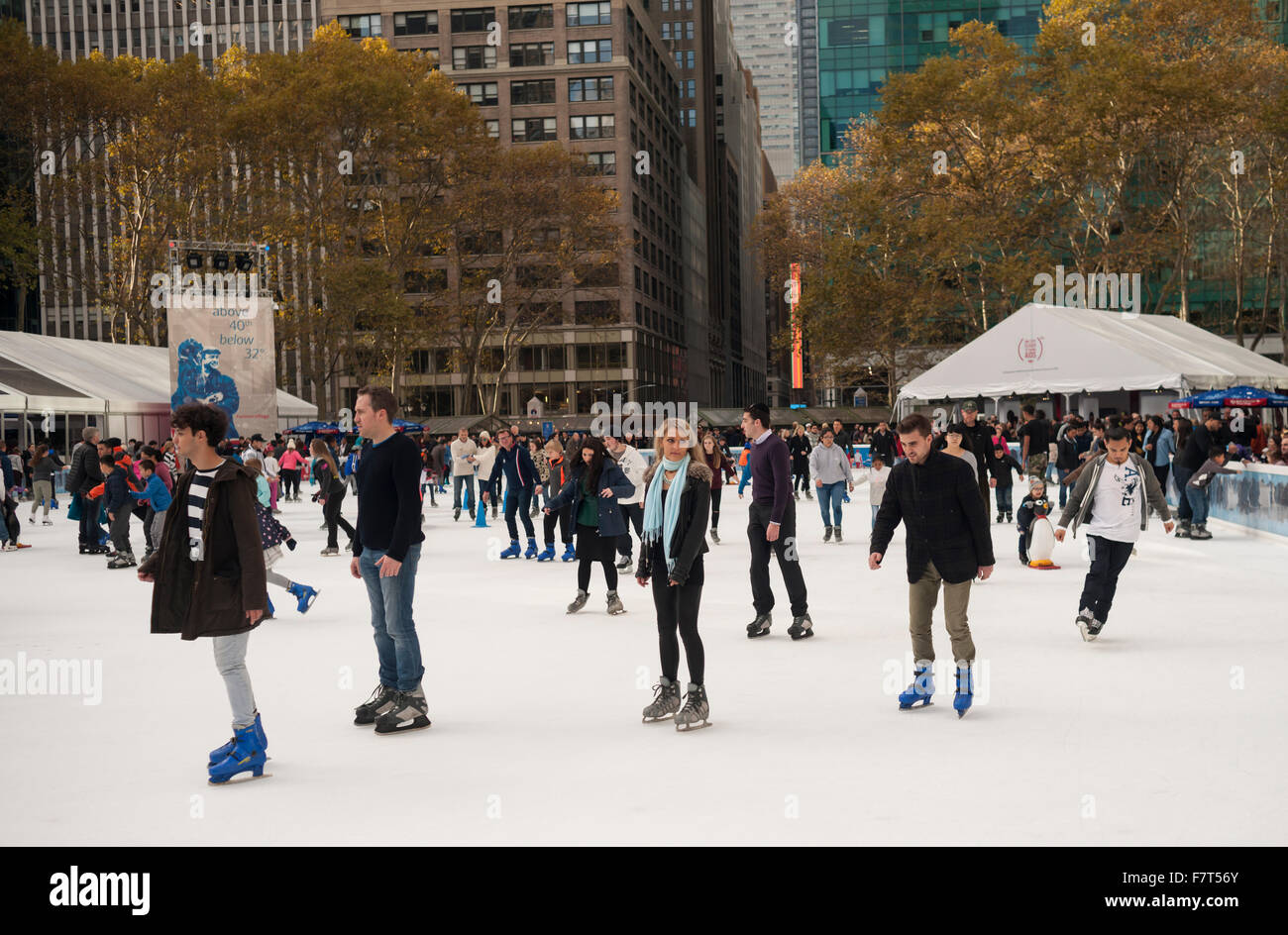 Skaters maneuver the packed Winter Village ice skating rink at Bryant ...