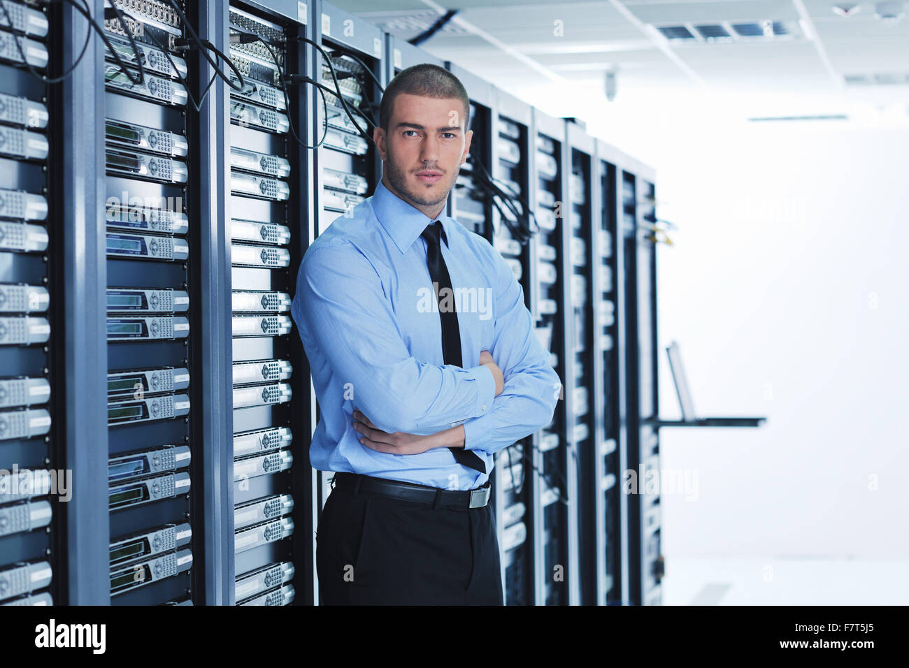 young handsome business man engeneer in datacenter server room Stock ...