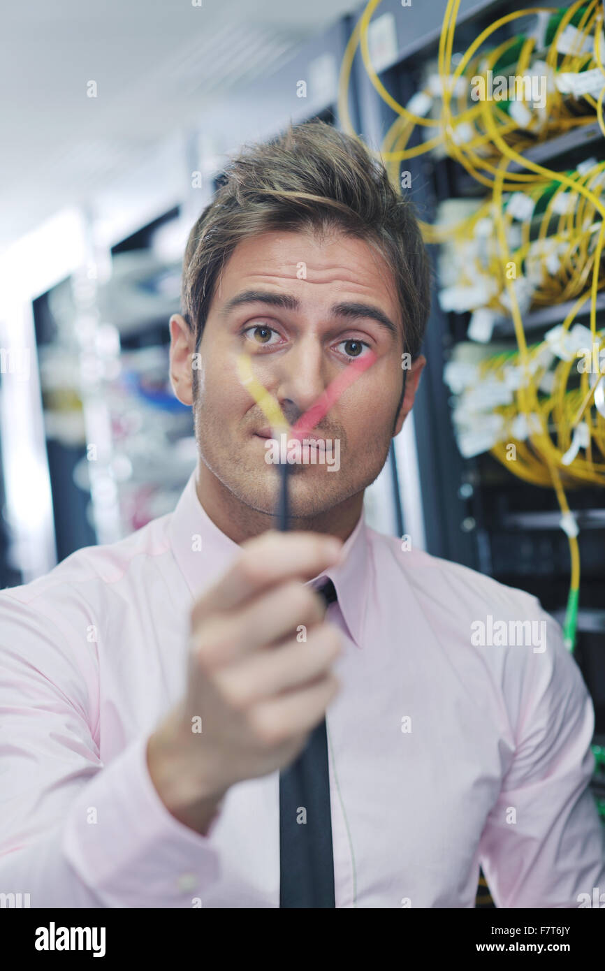 it business man in network server room have problems and looking for ...