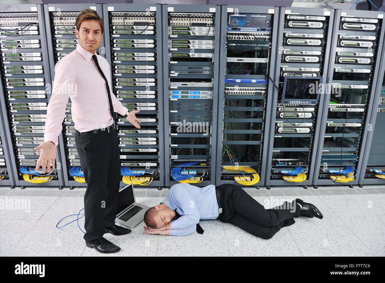 it business man in network server room have problems and looking for ...
