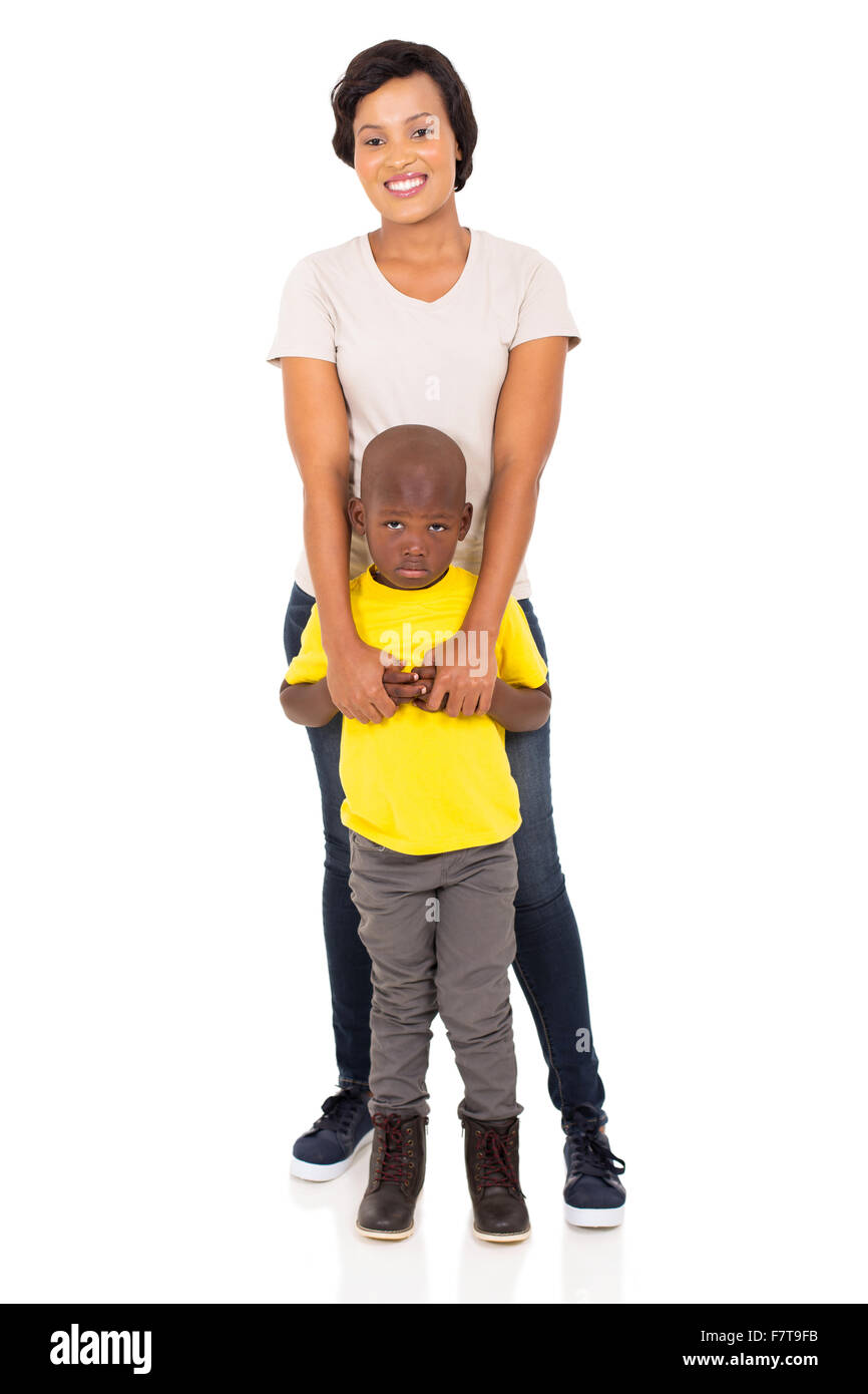 attractive African mother and son standing together on white background ...
