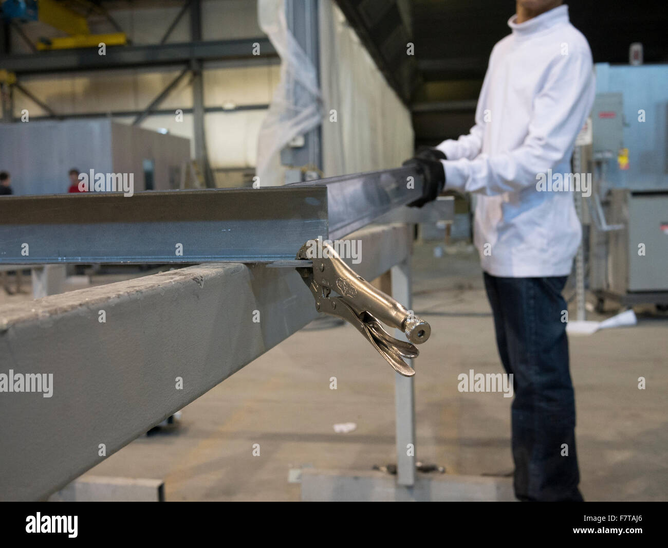 Worker binding metal frames with clamps for welding Stock Photo - Alamy
