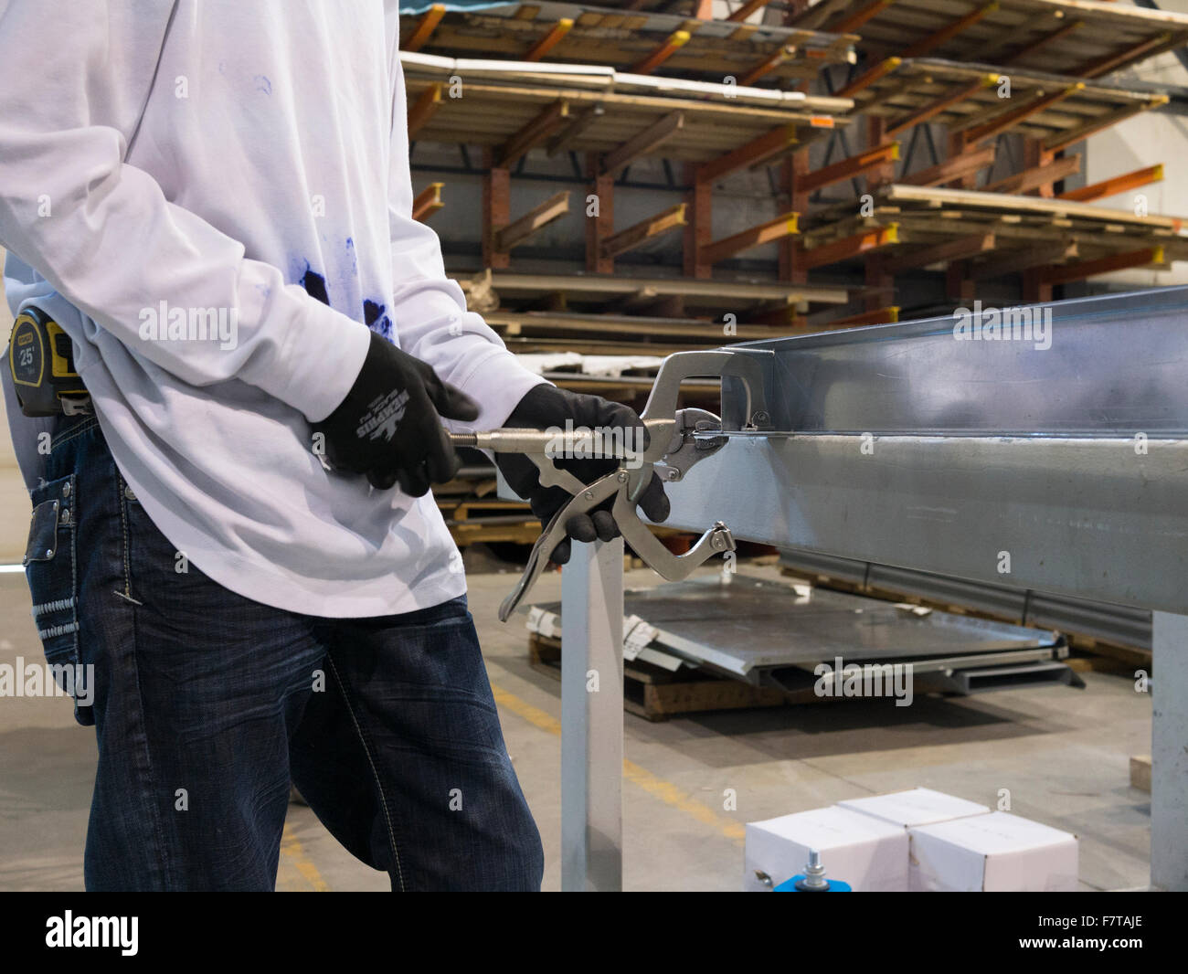 Worker binding metal frames with clamps for welding Stock Photo - Alamy