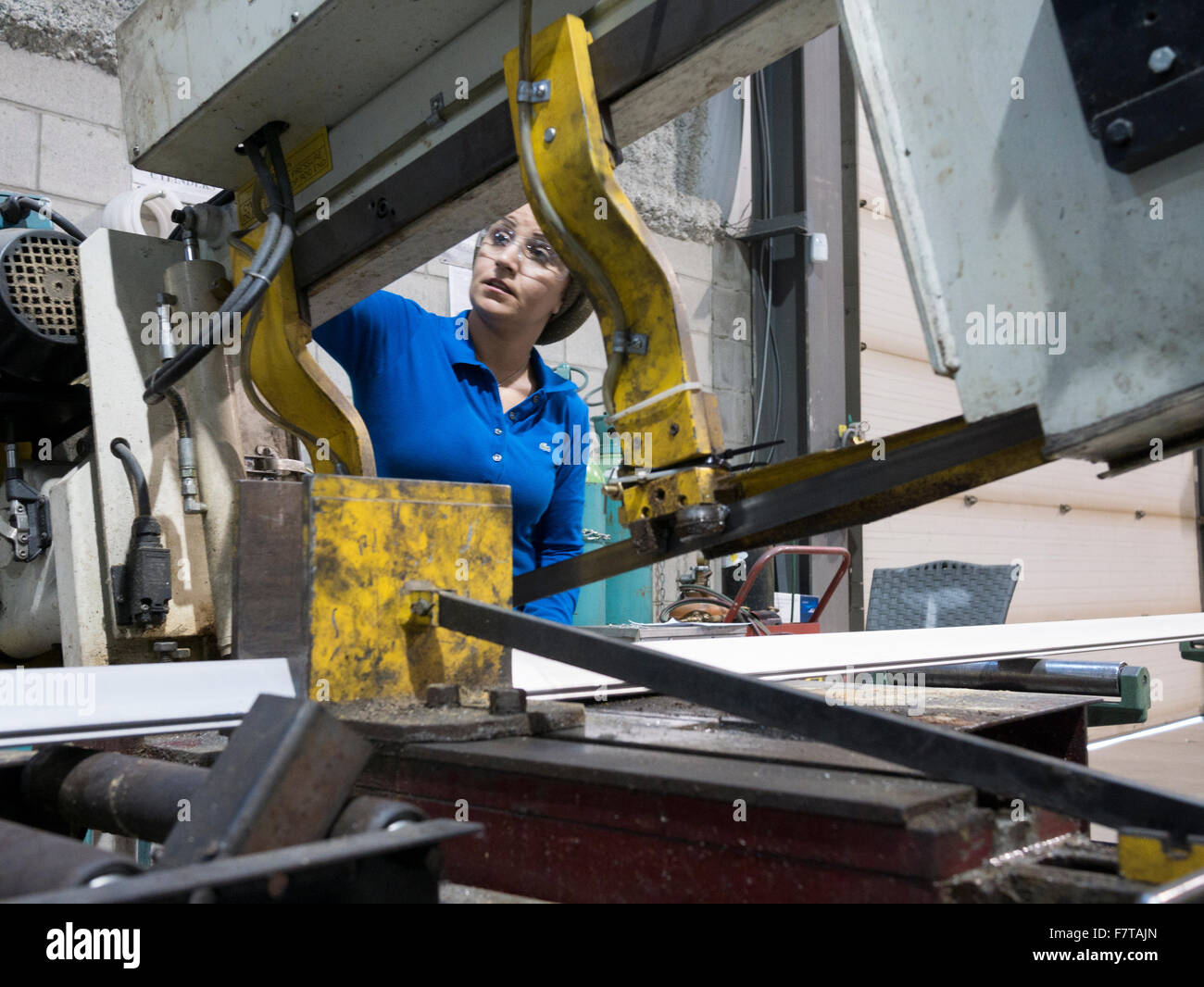 Female worker fine tuning machine for cutting a metal angle Stock Photo ...