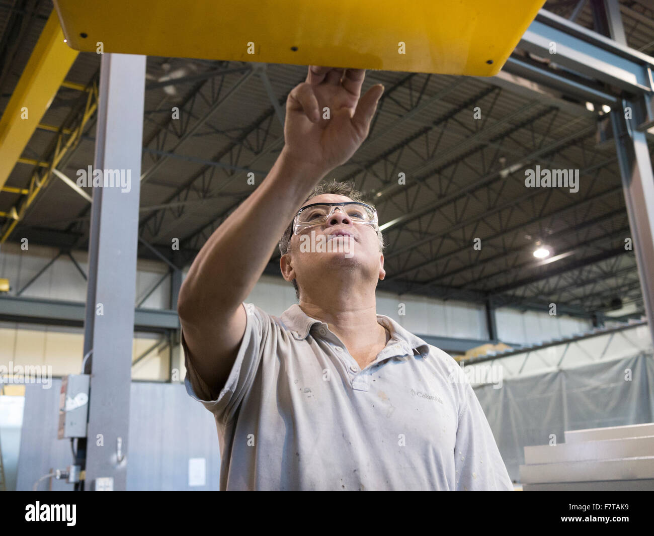 Industrial machine operator setting up hi-res stock photography and ...