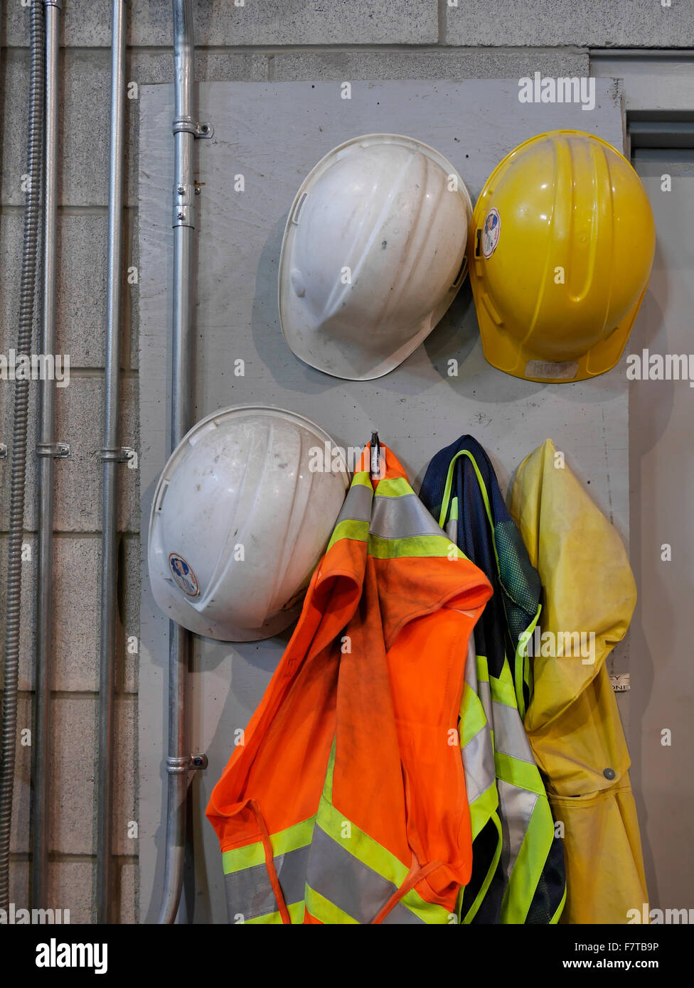 Worker safety clothes hung on a factory wall Stock Photo - Alamy