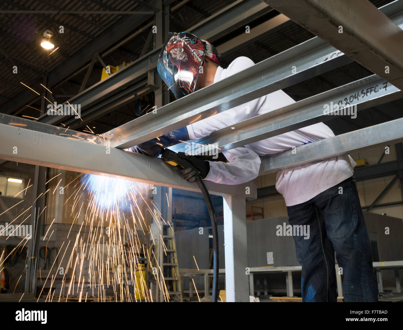Worker welding metal frames in HVAC manufacturing factory Stock Photo ...