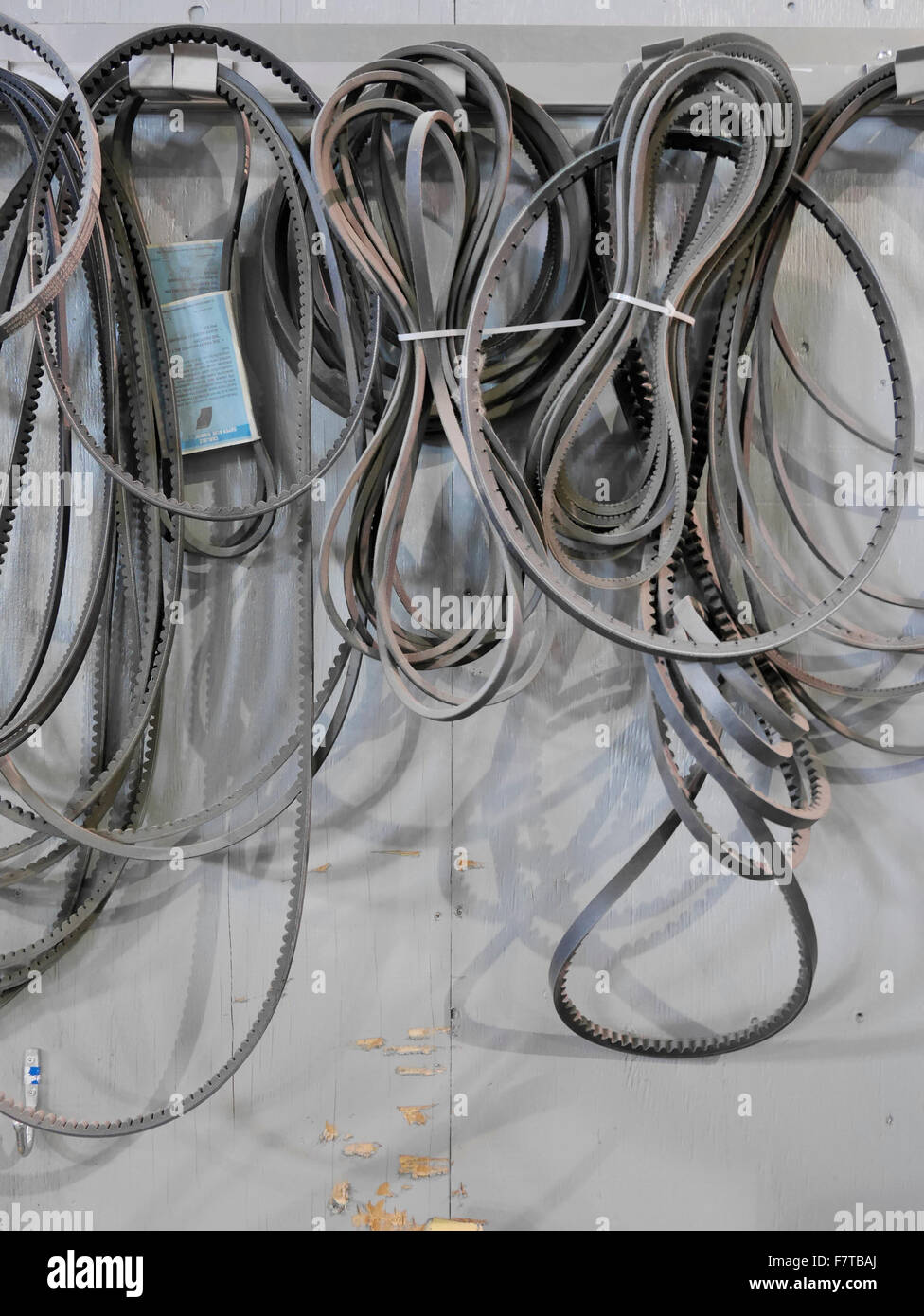 Machine and gear rubber belts hanging on a factory wall Stock Photo - Alamy