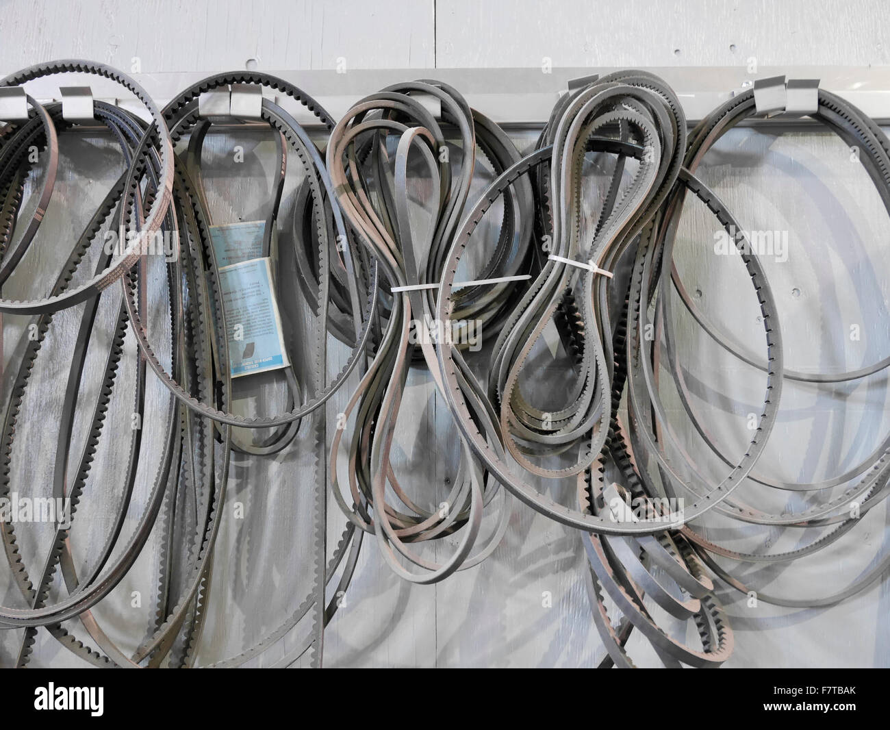 Machine and gear rubber belts hanging on a factory wall Stock Photo - Alamy