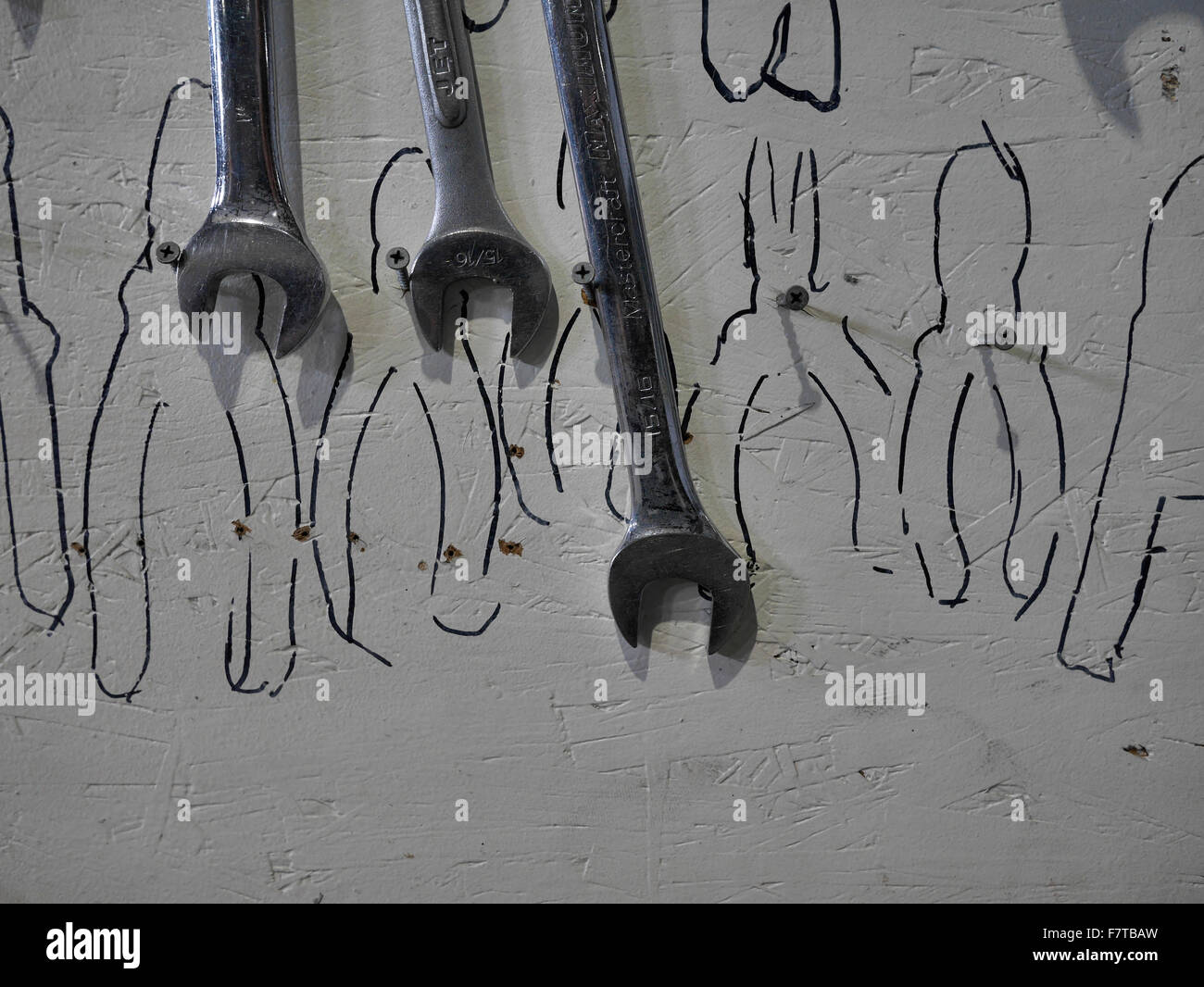 Tools hung on factory walls with tool outline on walls Stock Photo - Alamy