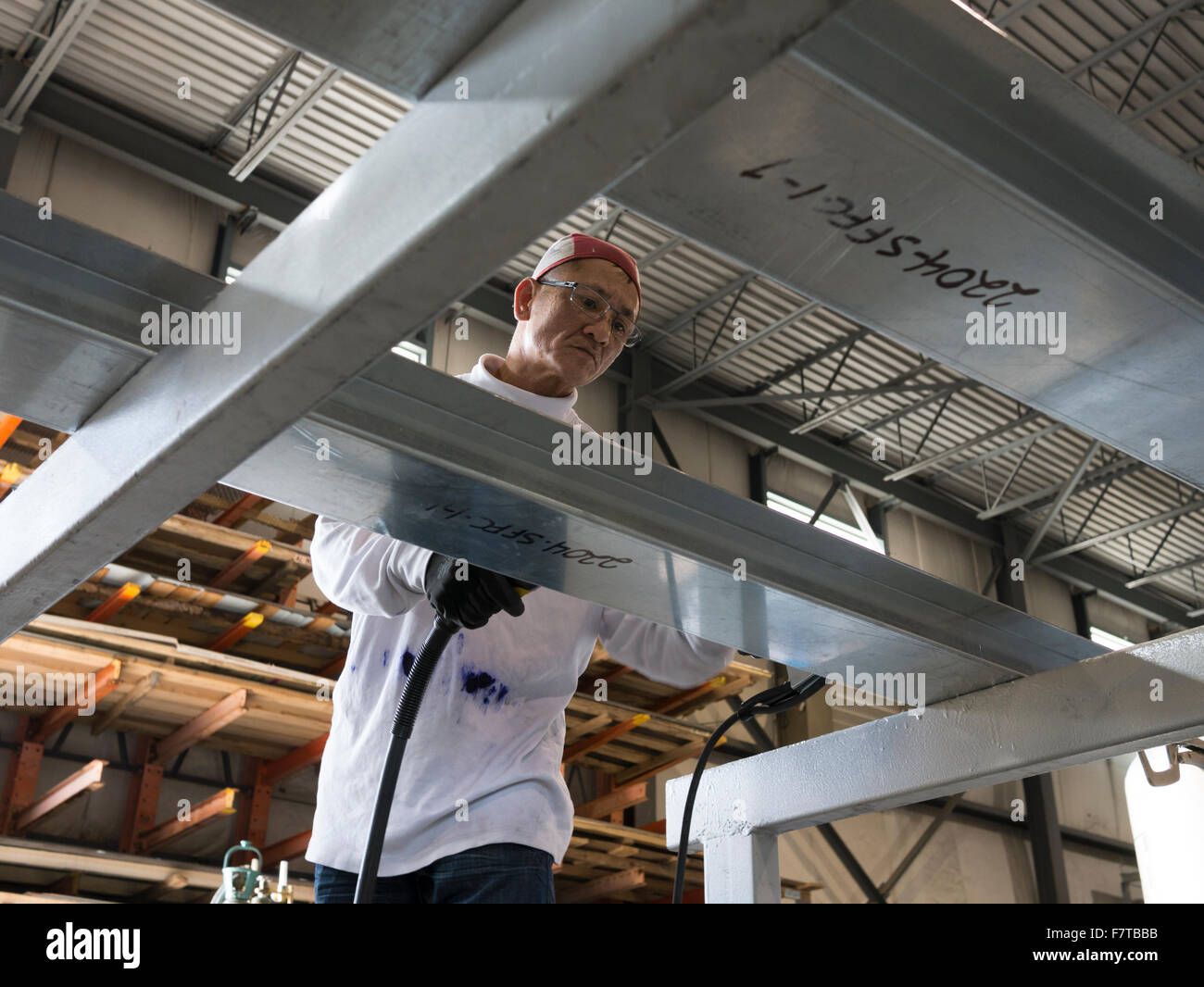 Worker welding metal frames in HVAC manufacturing factory Stock Photo ...
