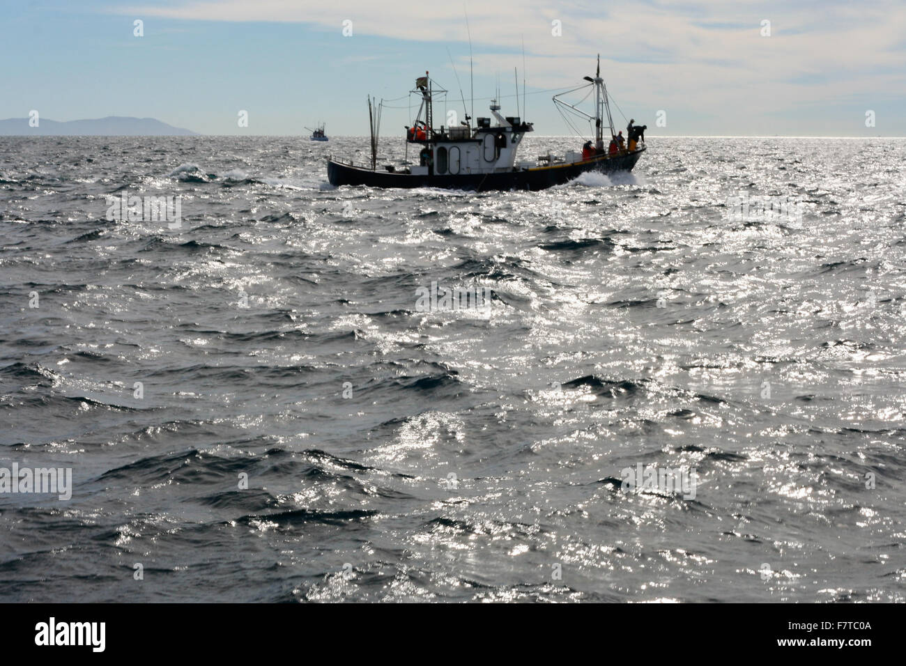 Fishing ship navigating by the Strait of Gibraltar at sunset, Tarifa ...