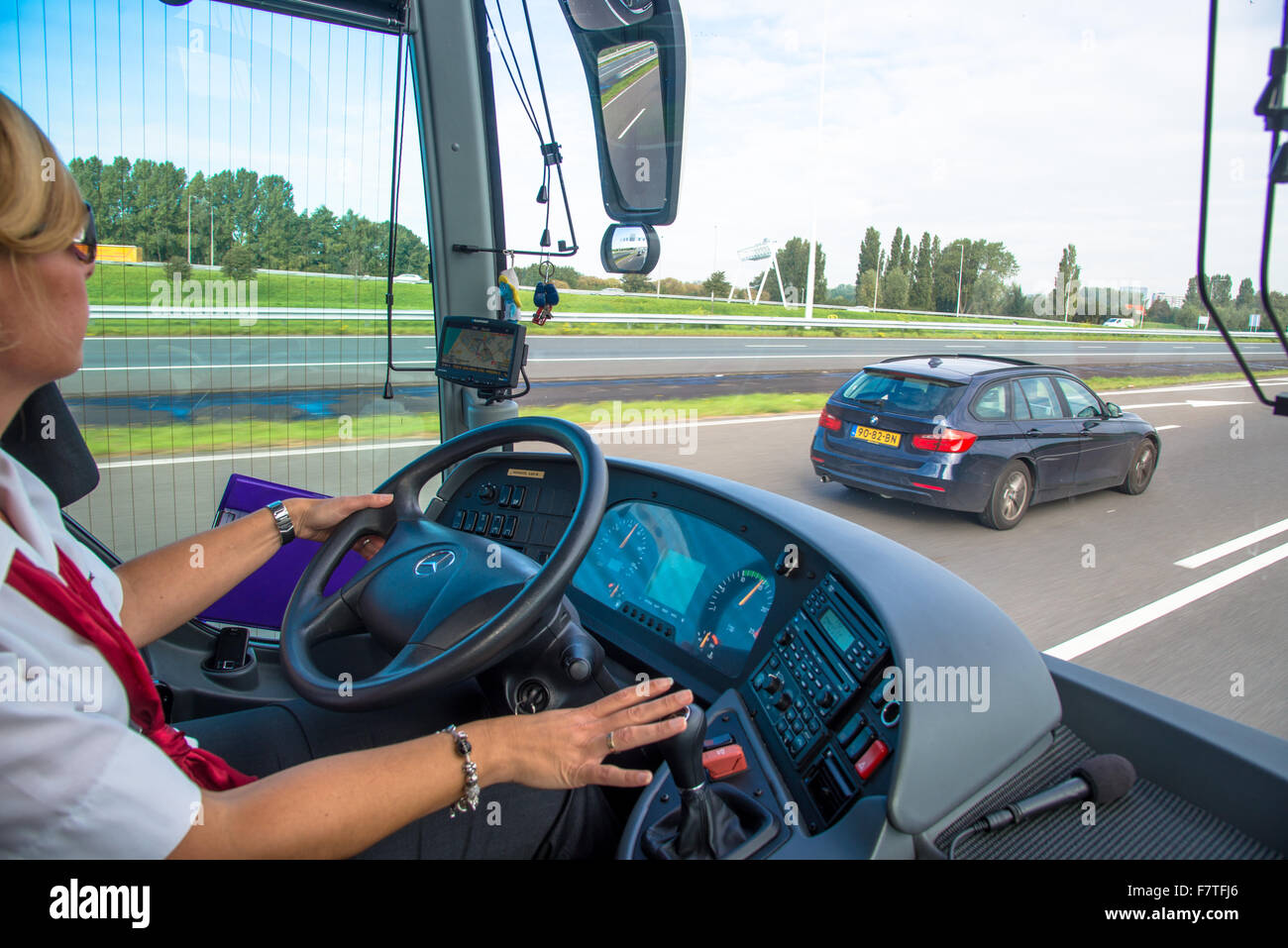 female busdriver behind steeringwheel in bus Stock Photo - Alamy