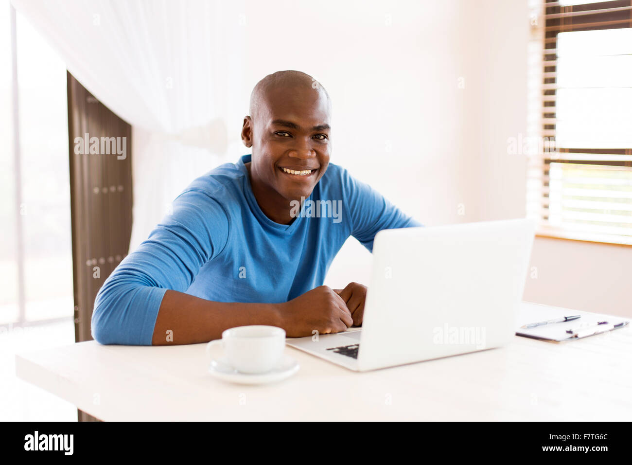 happy African man using laptop computer at home Stock Photo - Alamy