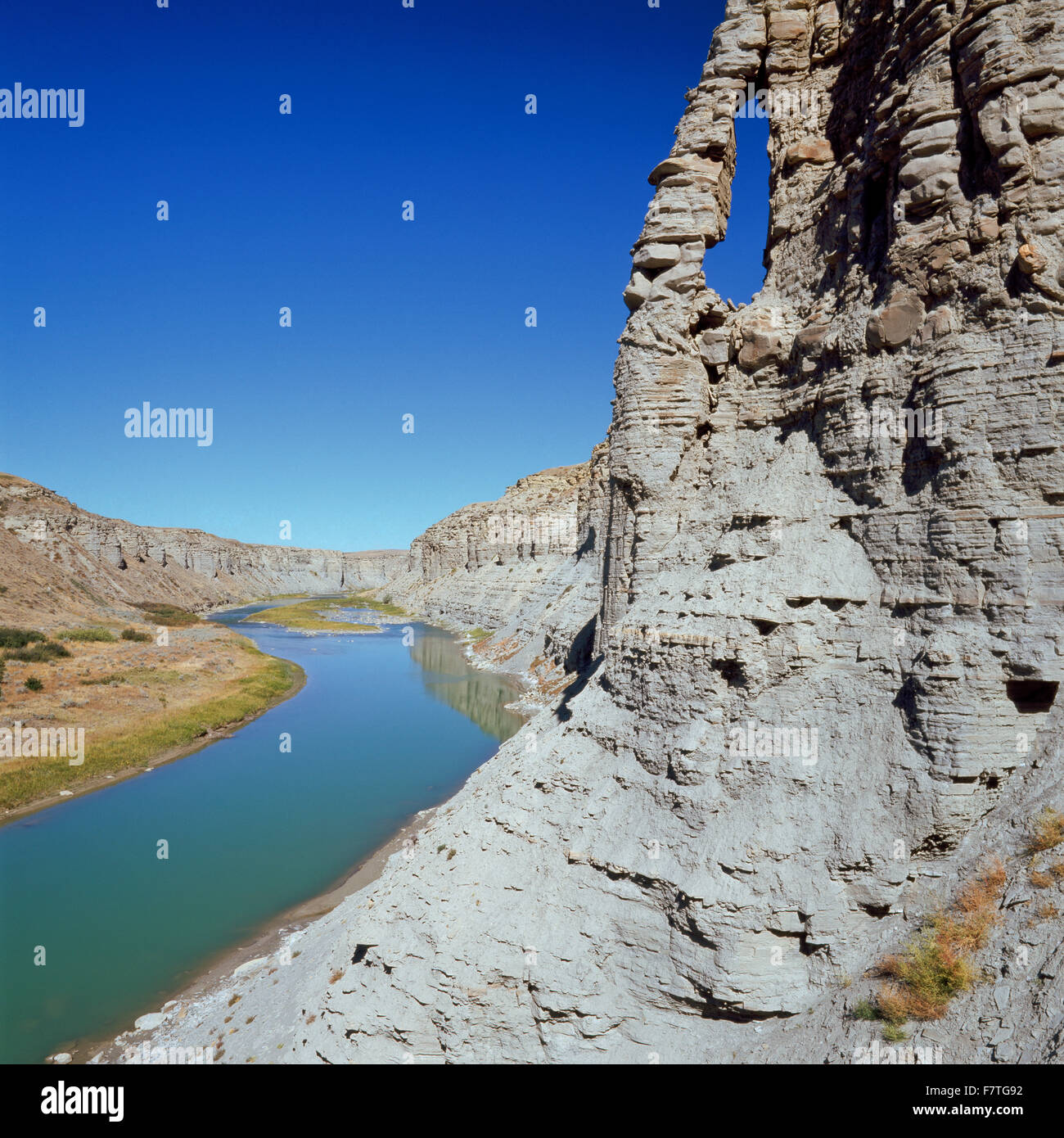 arch on a high cliff above the two medicine river in a canyon near ...