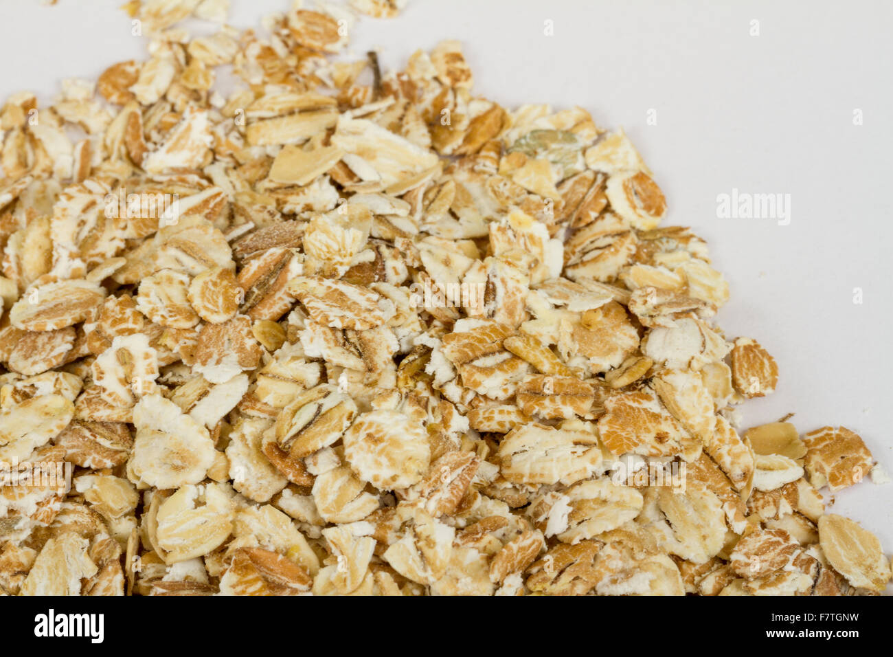 Heap of dry rolled oats isolated on white background Stock Photo - Alamy