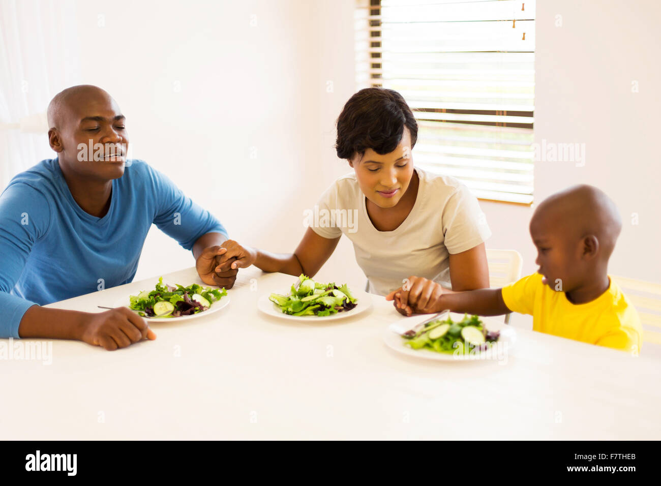 young African family praying before having meal at home Stock Photo - Alamy