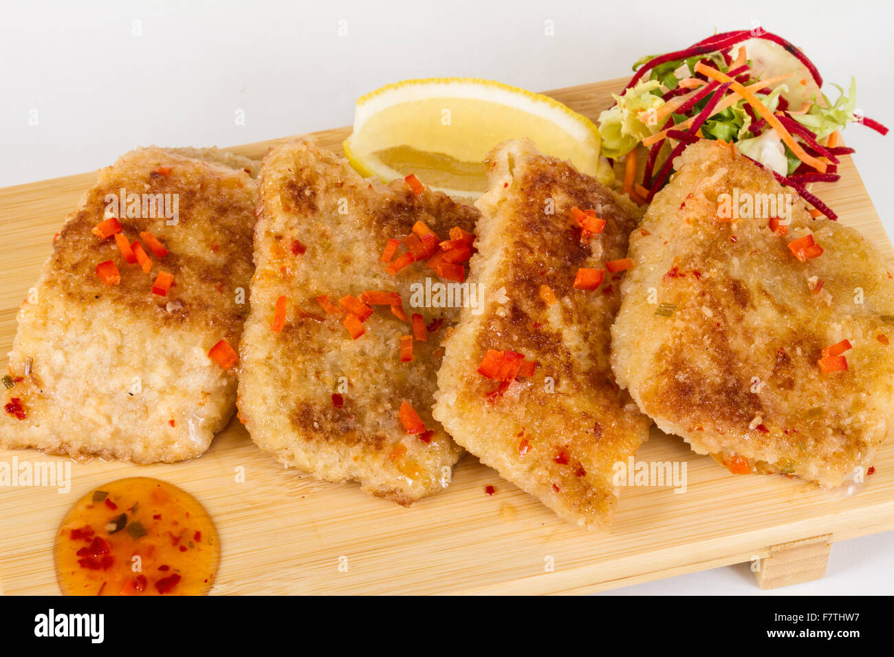 Fried fish fillets with salad Stock Photo - Alamy