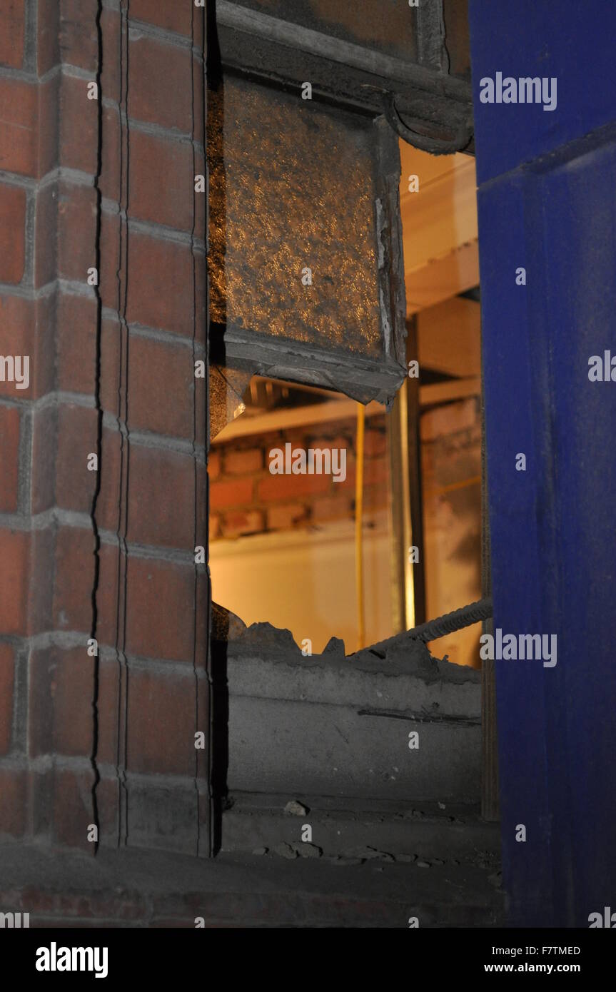 bright light coming from a building with a smashed window Stock Photo ...