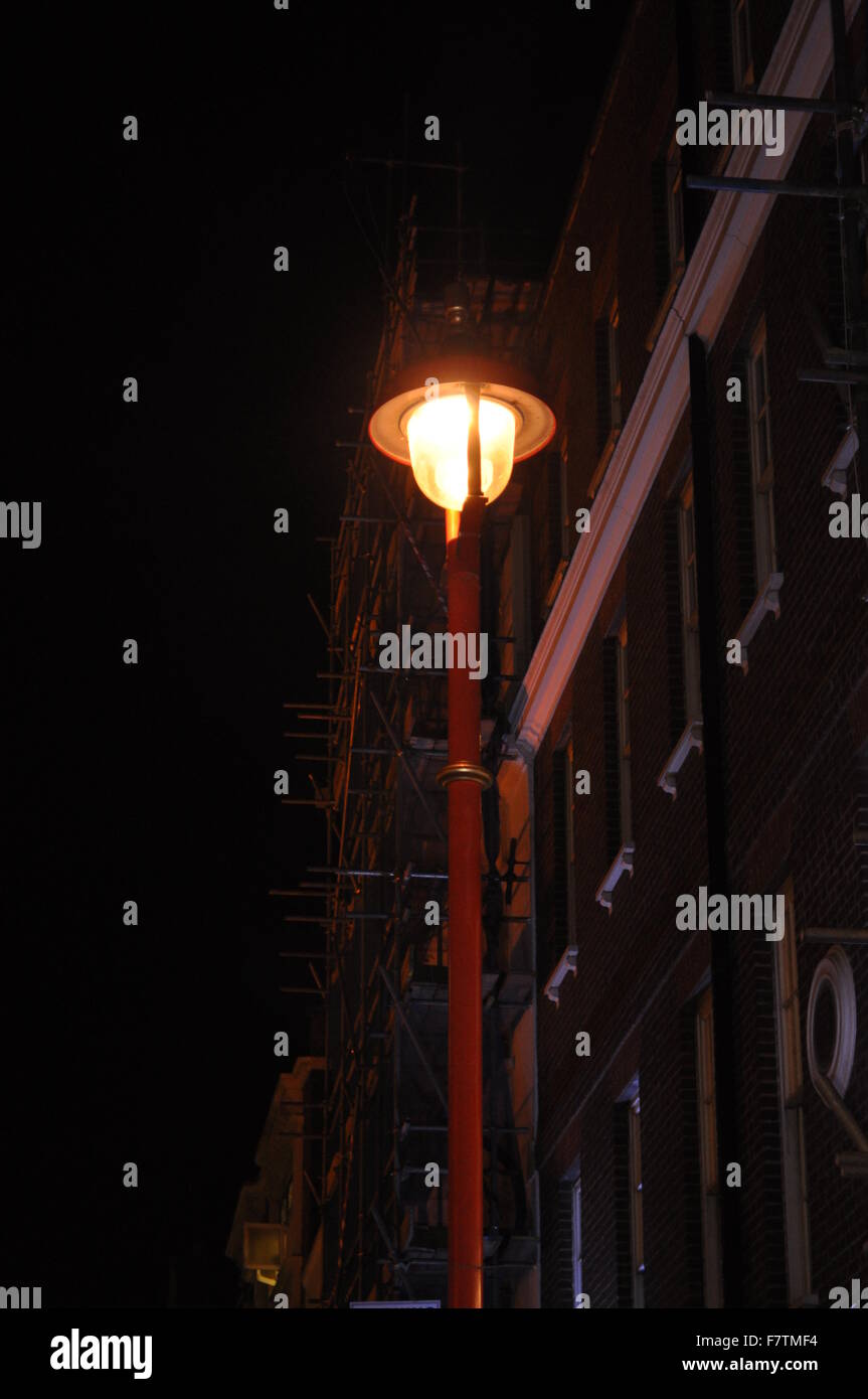 red street lamp brightly lit at night Stock Photo - Alamy