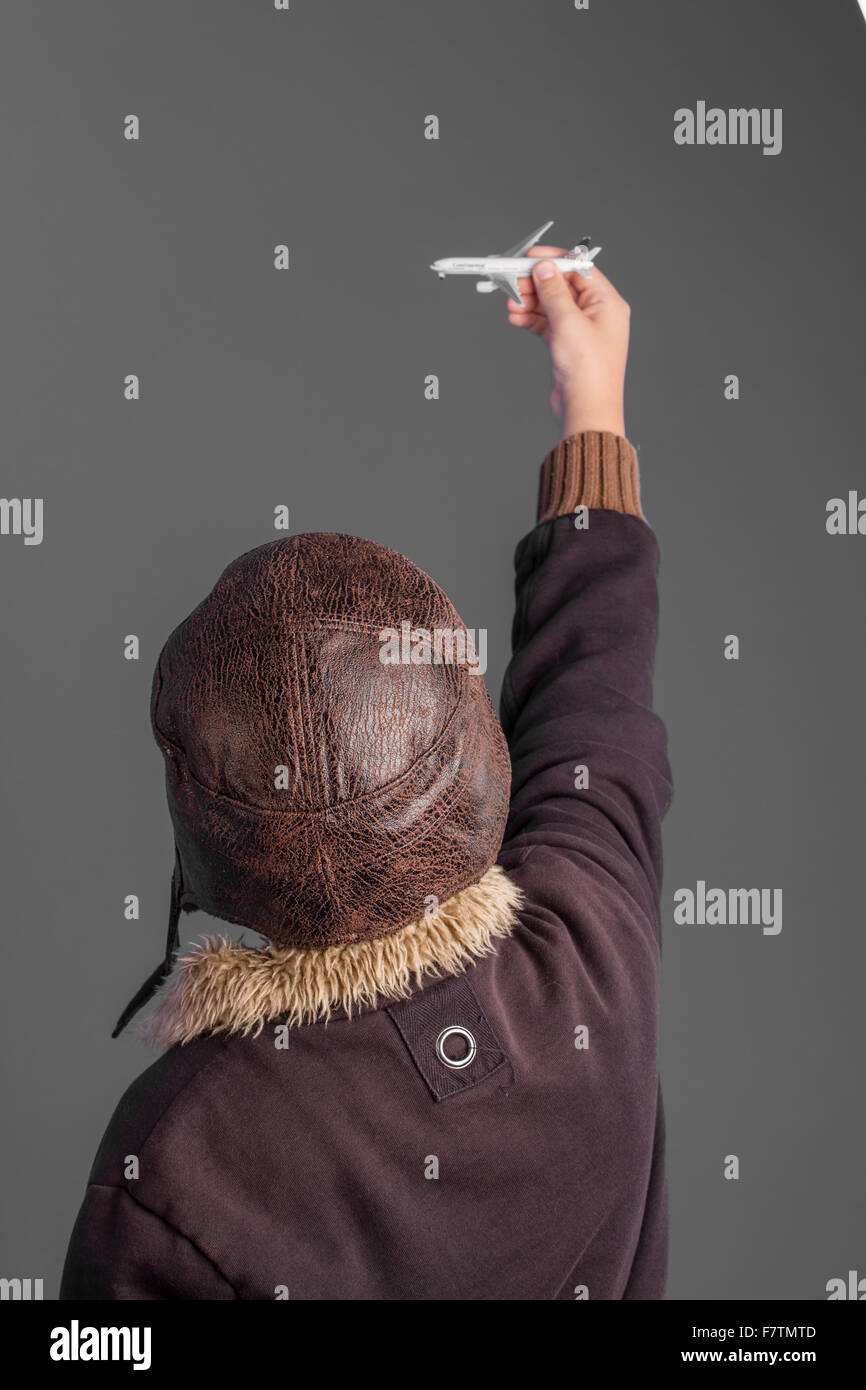 child playing the aircraft pilot with hat and retro bomber jacket Stock ...