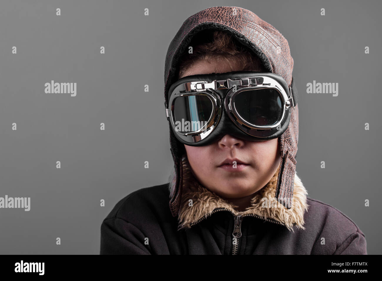 child playing the aircraft pilot with hat and retro bomber jacket Stock ...