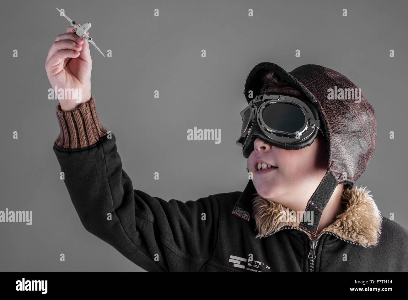 success, child playing the aircraft pilot with hat and retro bomber ...
